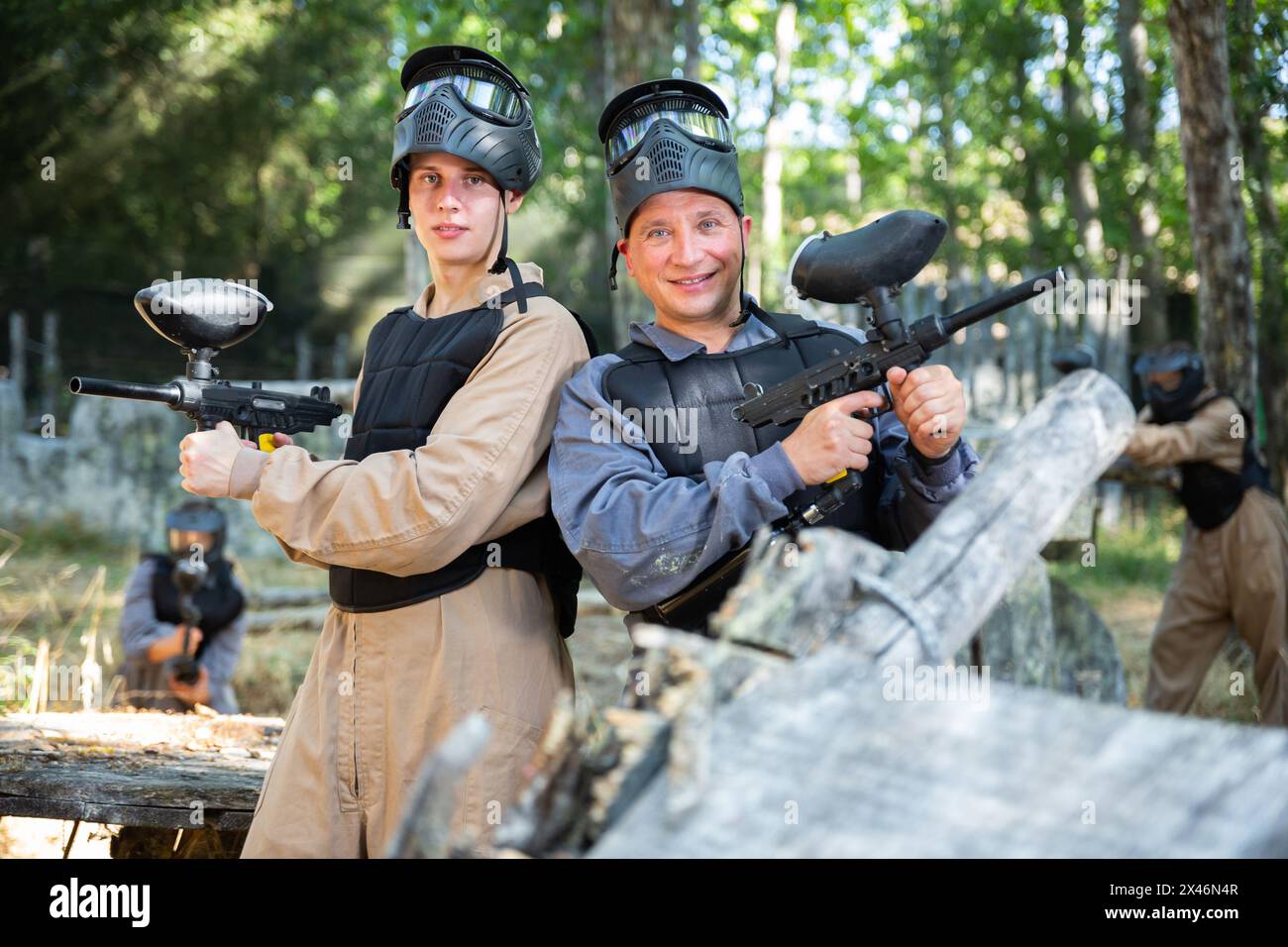 Two smiling paintball players in full gear having fun before game Stock ...