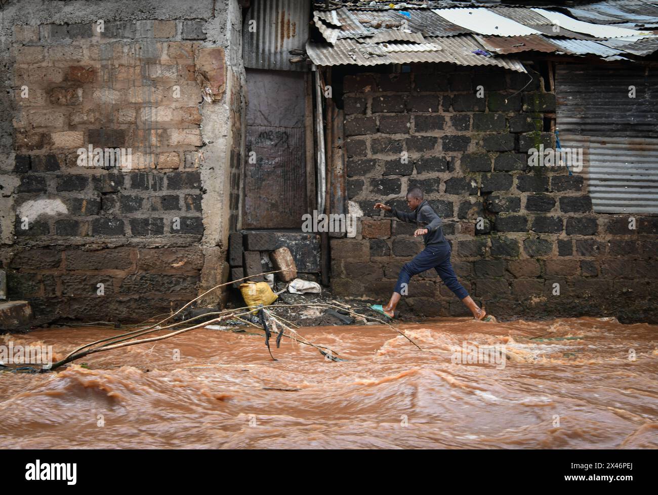 Nairobi, Kenya. 30th Apr, 2024. A boy wades across floodwater in the ...