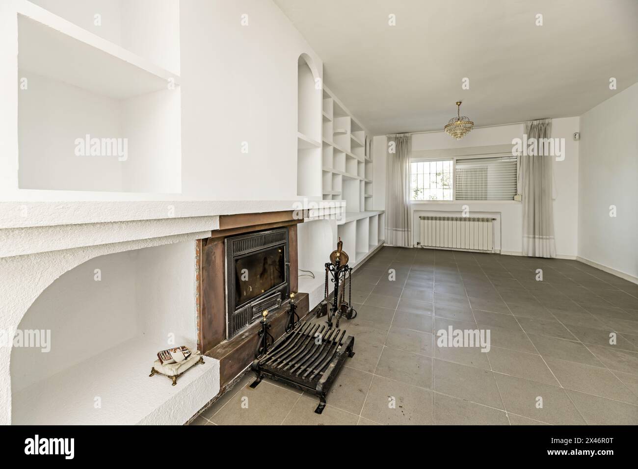 Fireplace of a house with a security grill on a wall with white built ...
