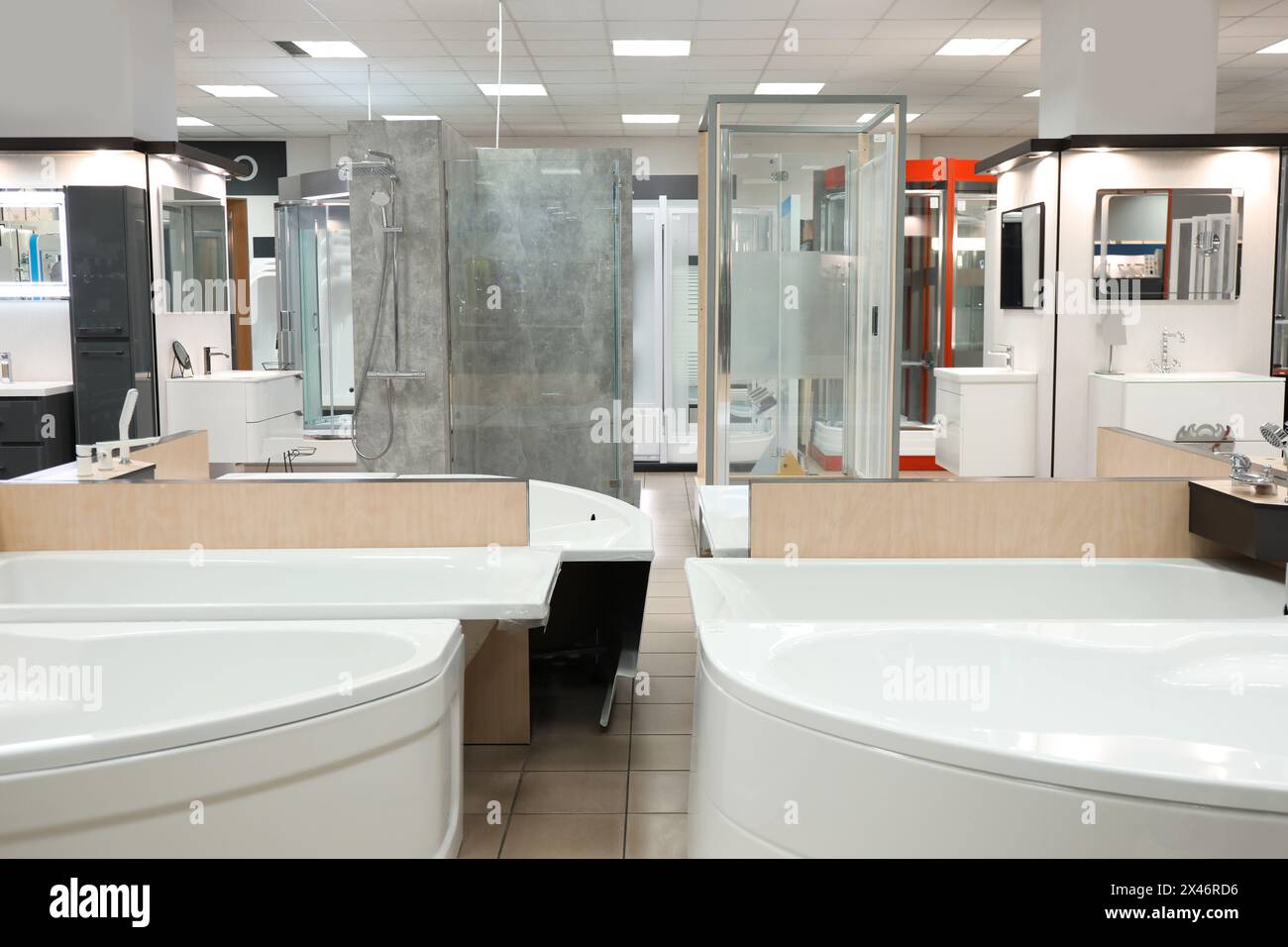 Plumbing department with shower stalls, trays and vanity units in store ...