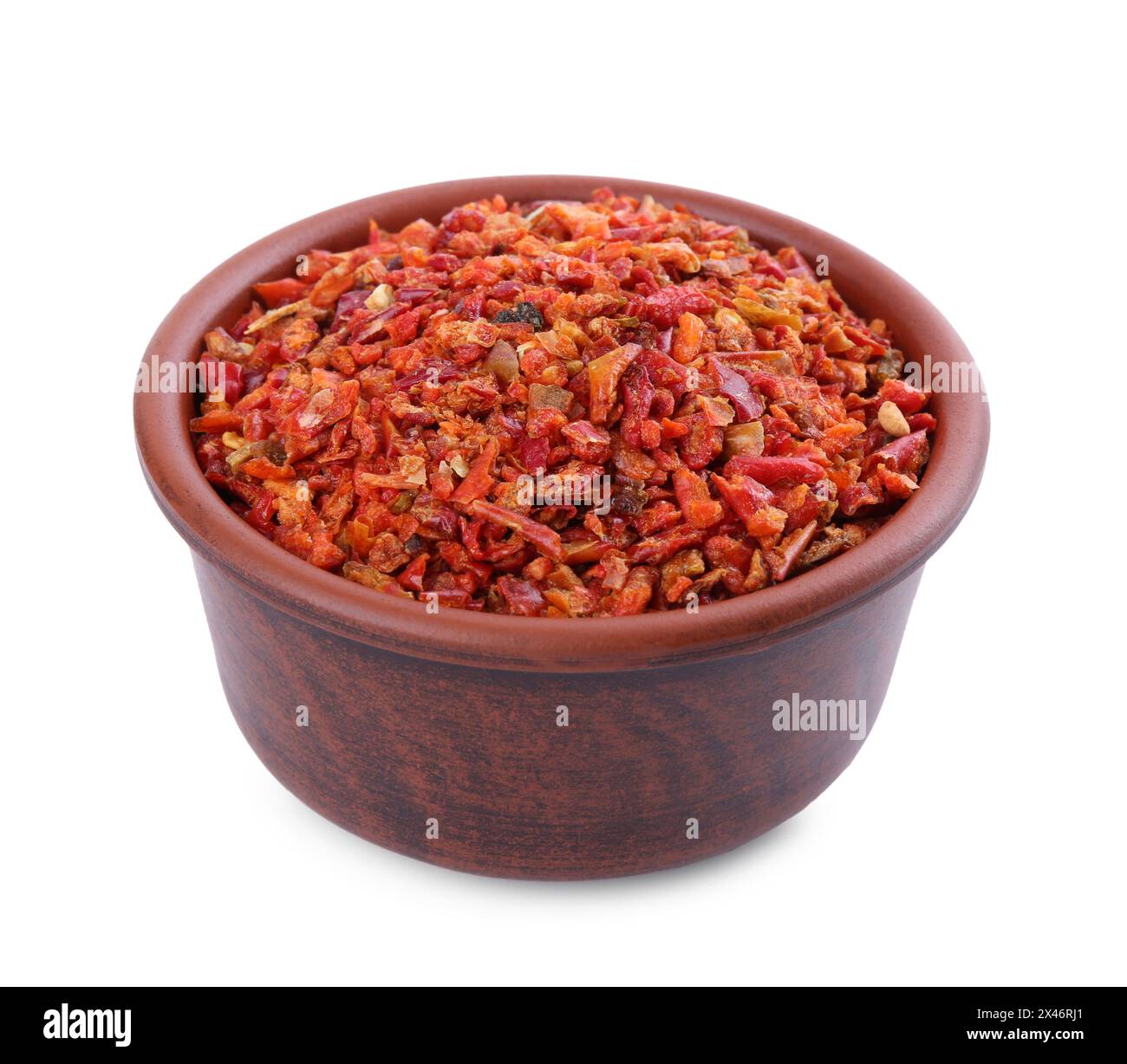 Aromatic spice. Red chili pepper flakes in bowl isolated on white Stock ...