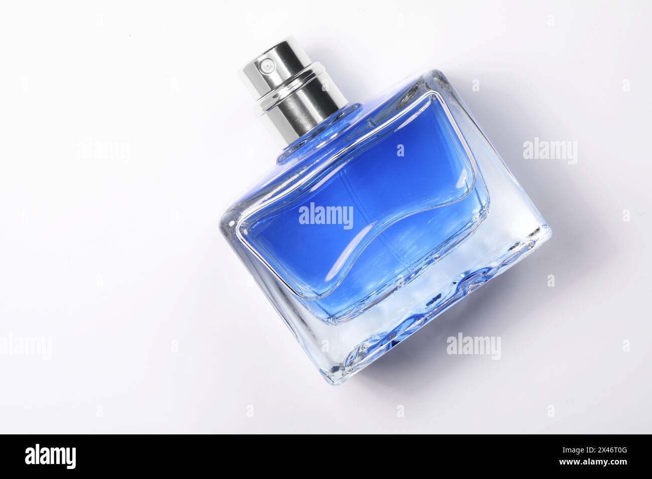 Blue men's perfume in bottle on white background, top view Stock Photo ...
