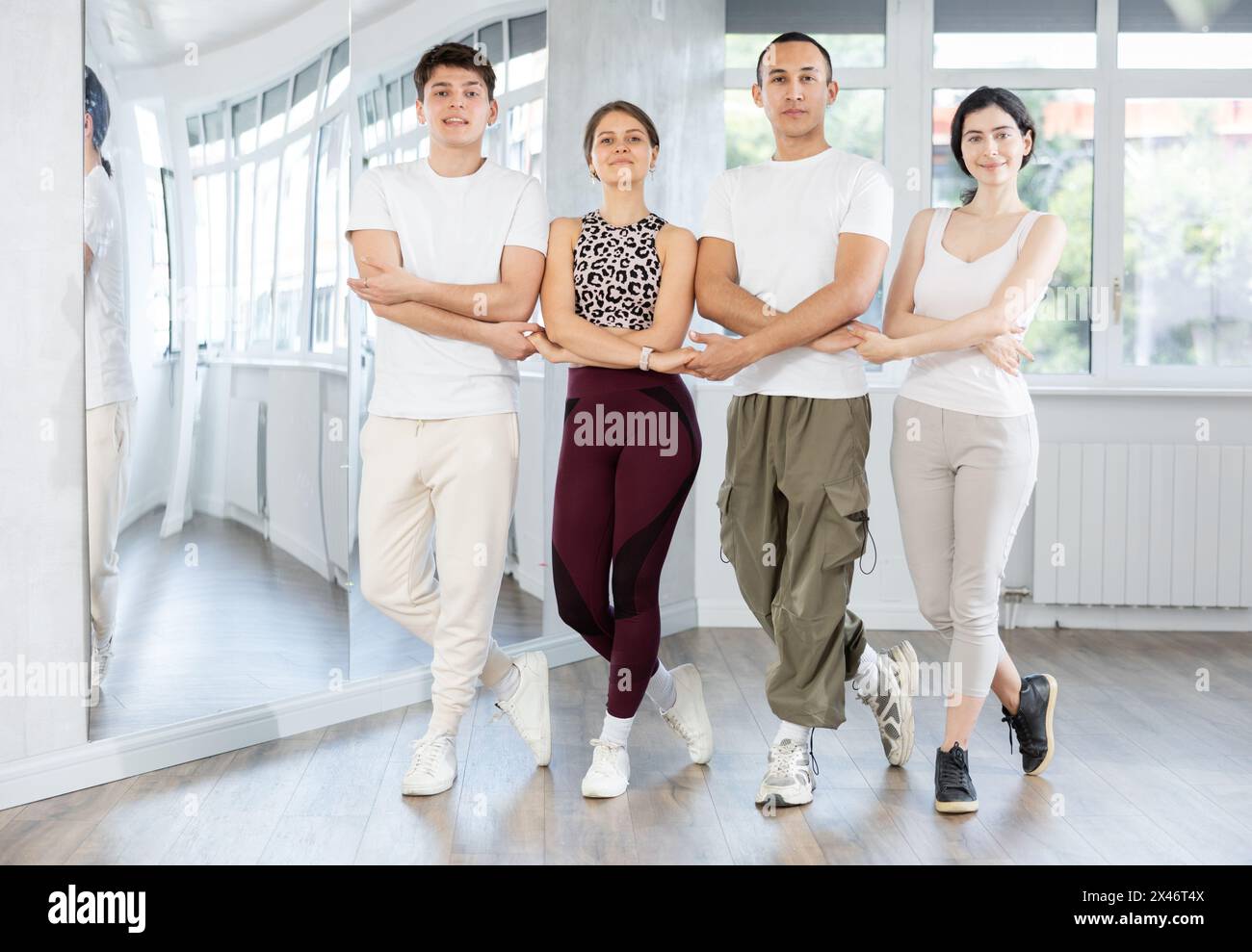 Group of young people stand in row holding hands, performing Irish folk ...
