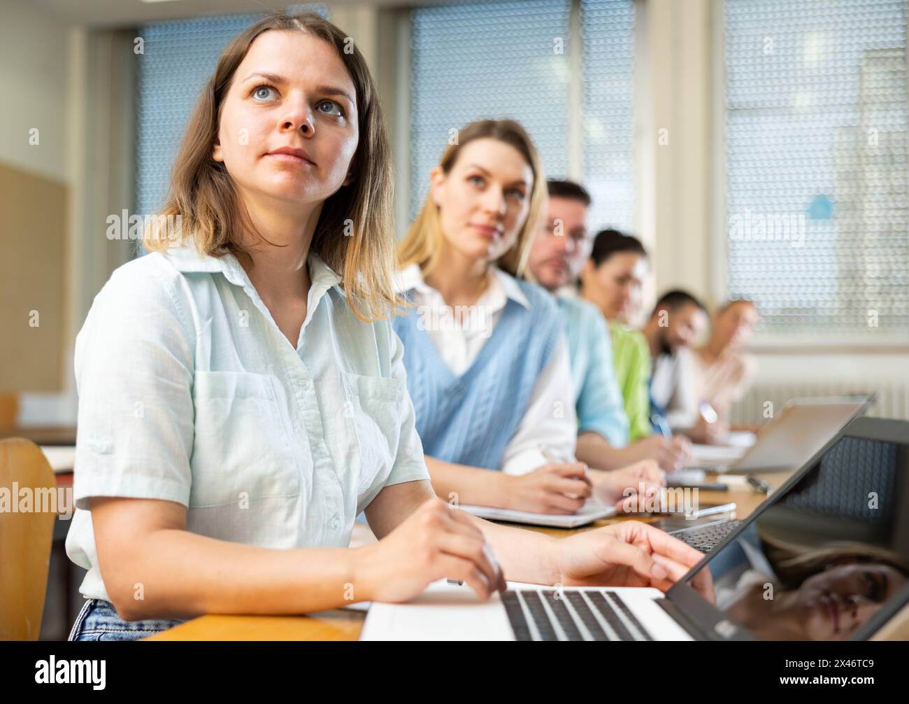 Woman university student writing in classroom Stock Photo - Alamy