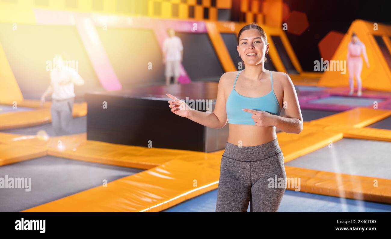 Young woman in sport clothes high jumping in trampoline arena Stock ...