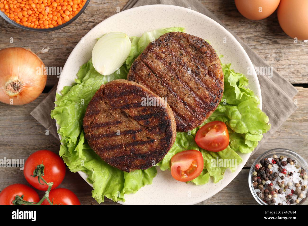 Vegetarian product. Tasty lentil cutlets served on wooden table, flat ...