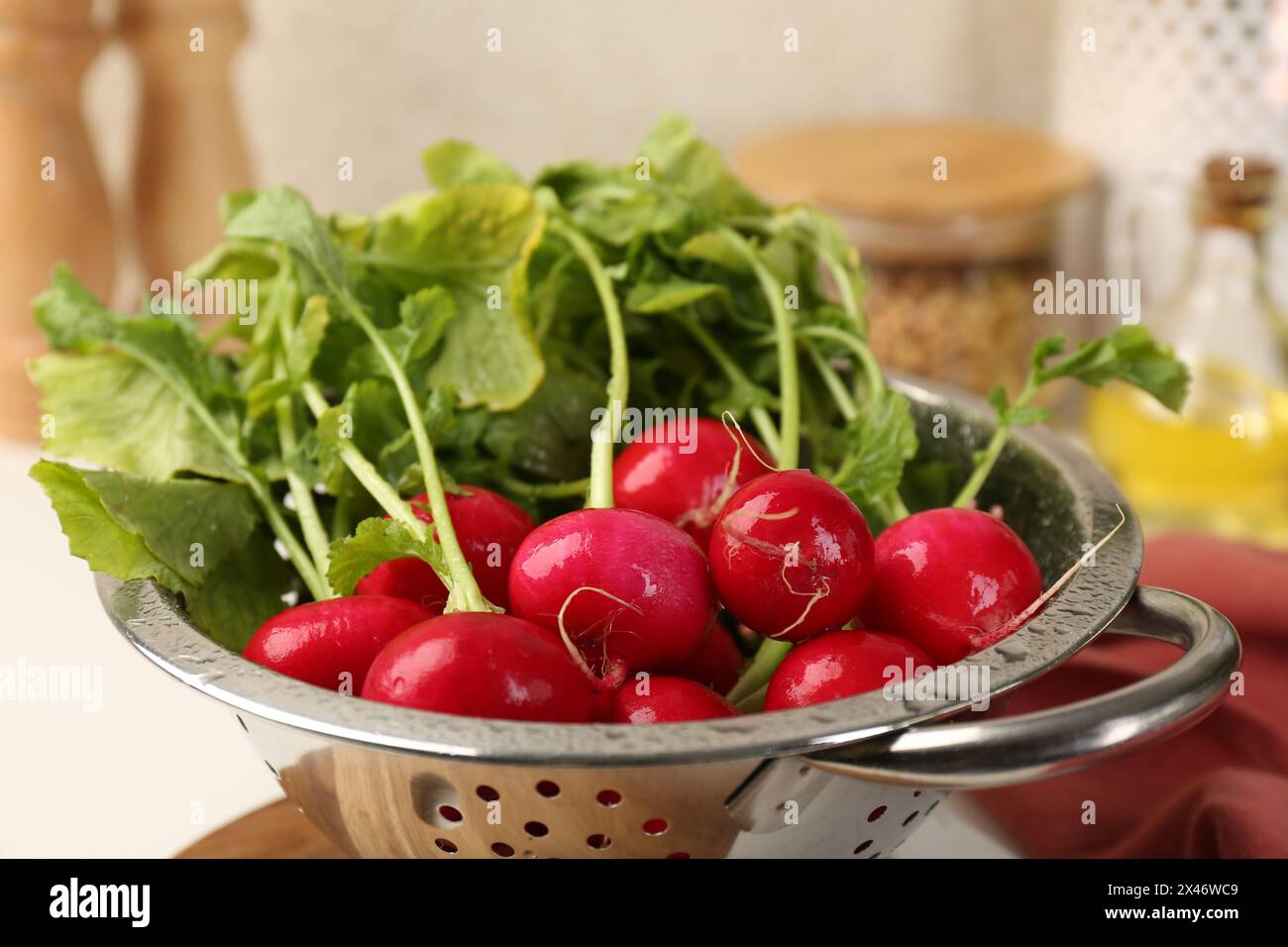 Wet radish in colander on white table, closeup Stock Photo - Alamy