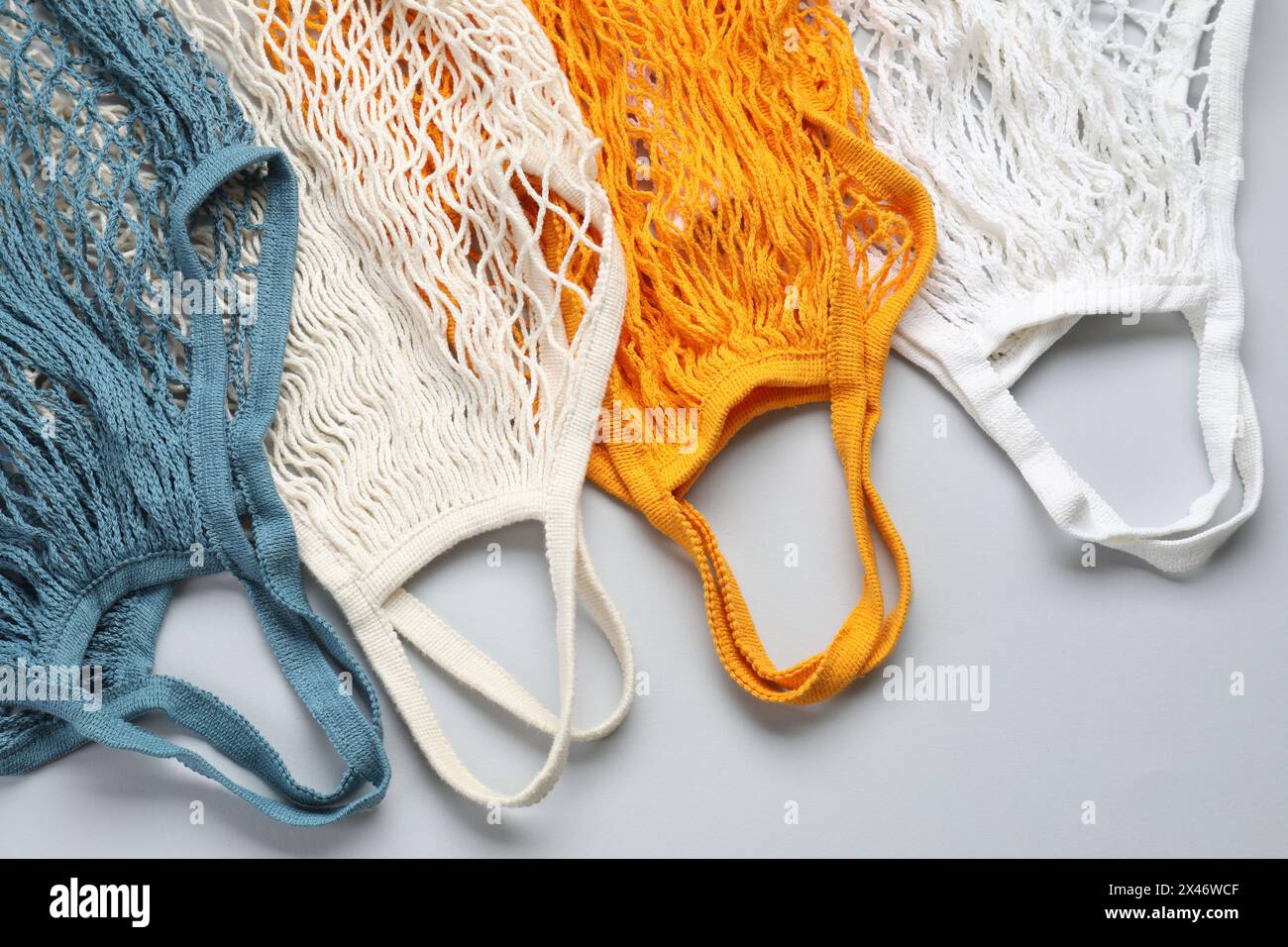 Different string bags on light grey background, top view Stock Photo ...