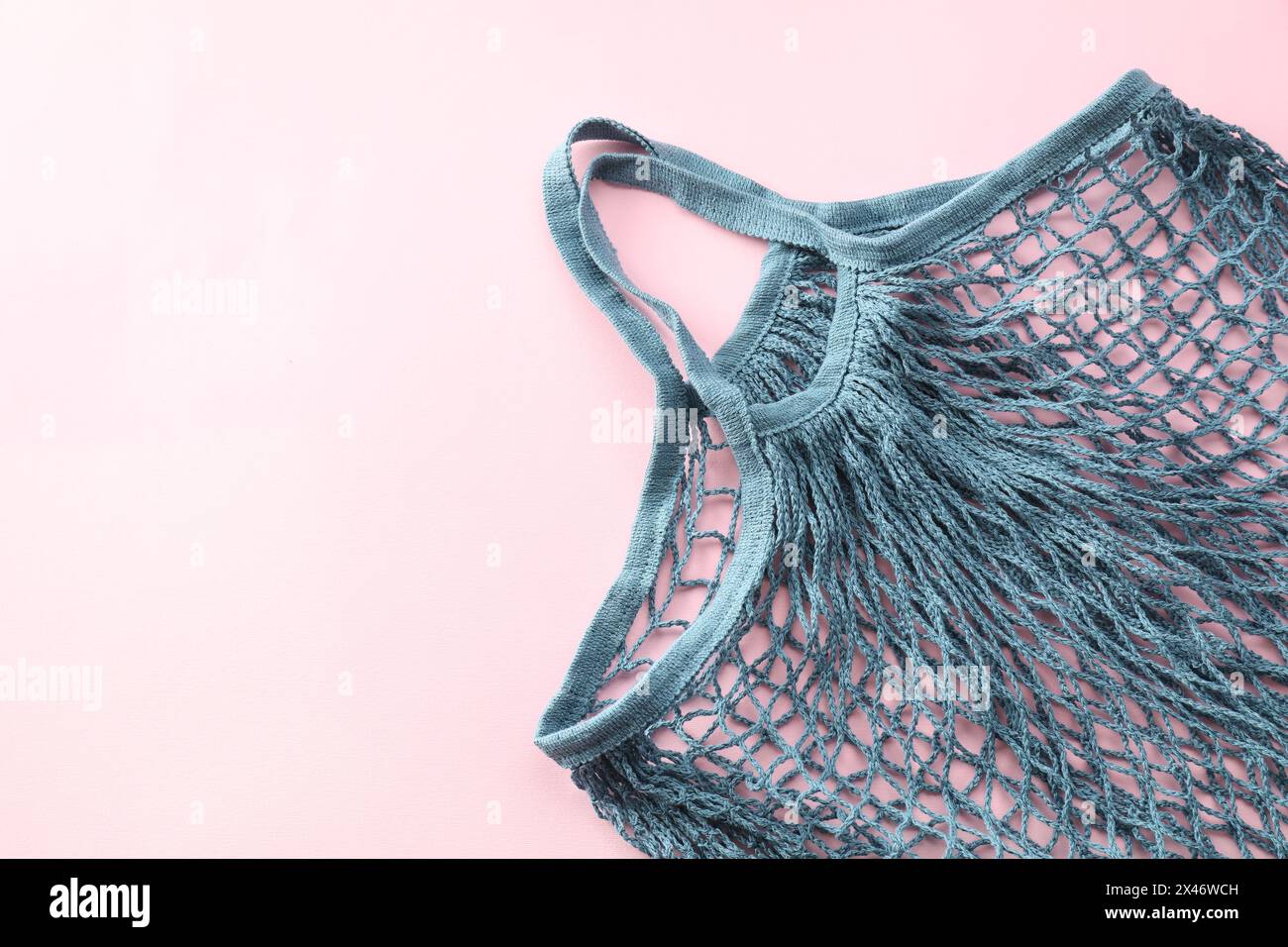 Blue string bag on pink background, top view. Space for text Stock ...