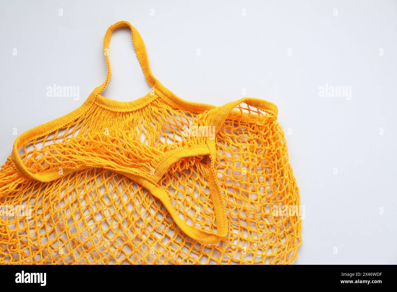 Orange string bag on light grey background, top view Stock Photo - Alamy