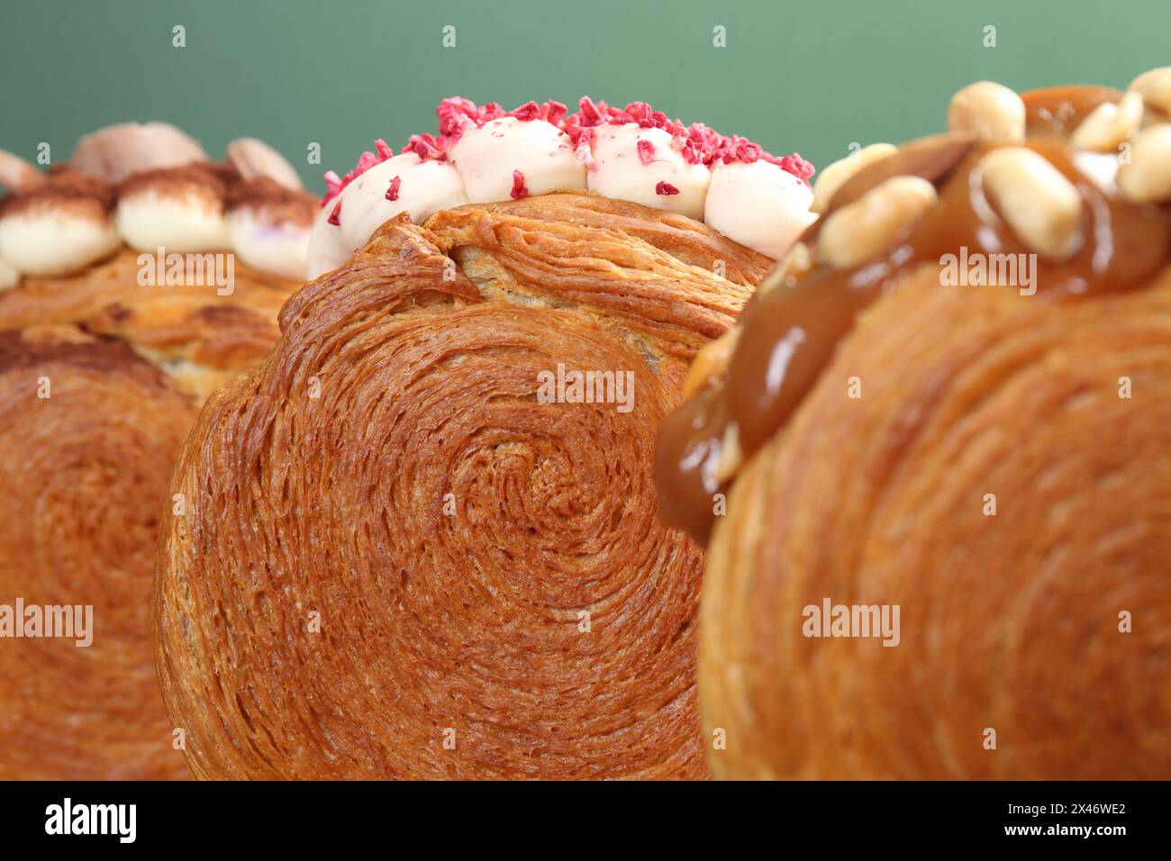 Crunchy round croissants on pale green background, closeup. Tasty puff ...