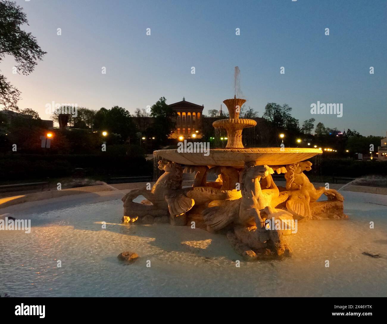 The Fountain of the Sea Horses is lit just before daybreak behind the ...