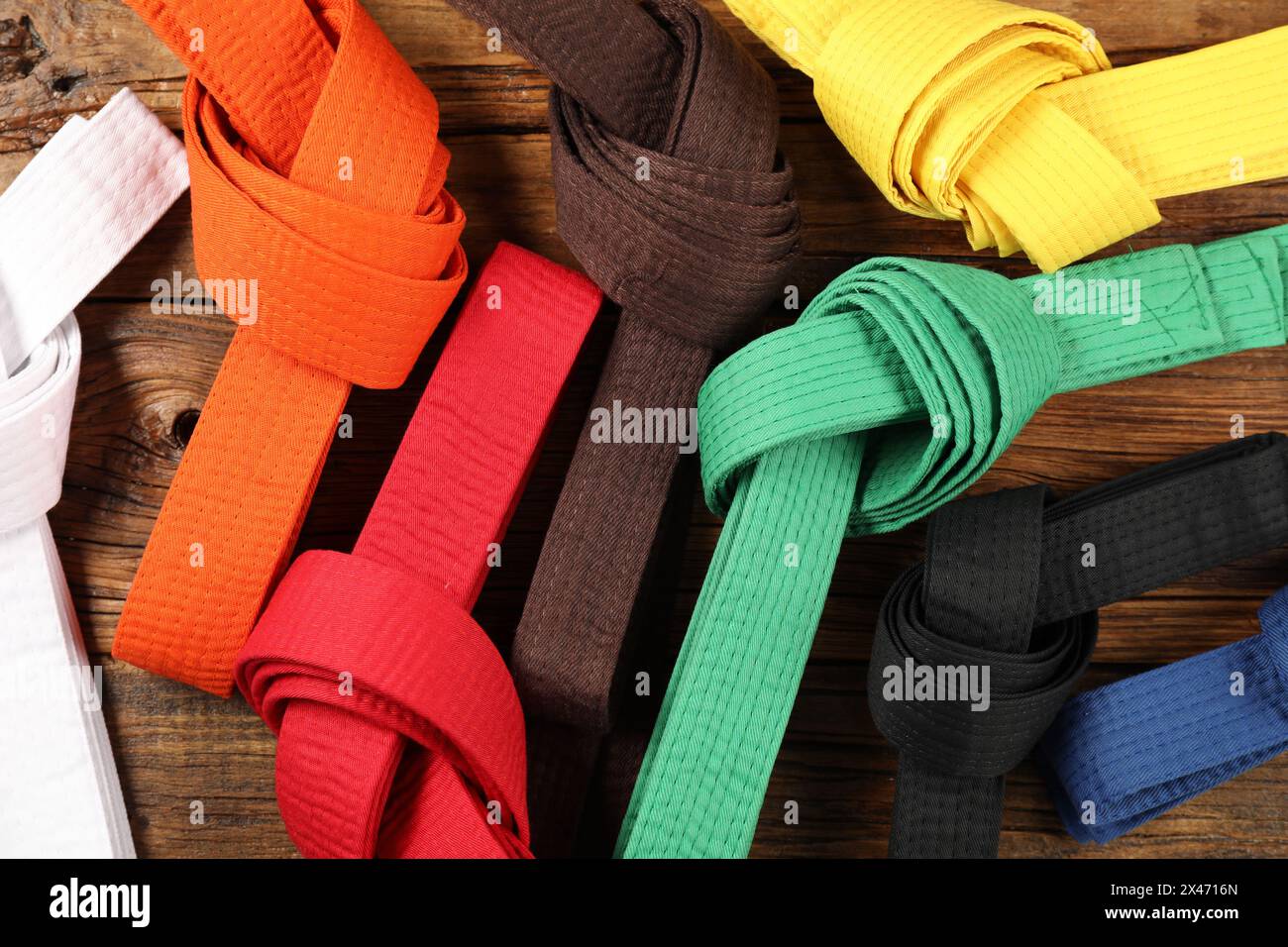 Colorful karate belts on wooden background, flat lay Stock Photo - Alamy