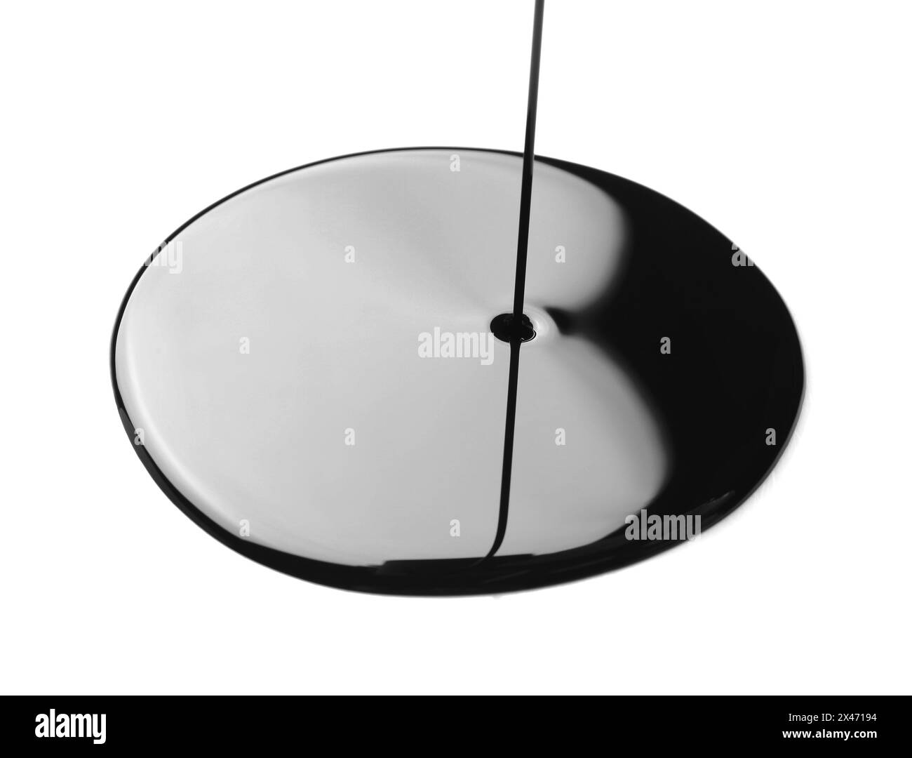 Oil pouring to puddle on white background Stock Photo - Alamy