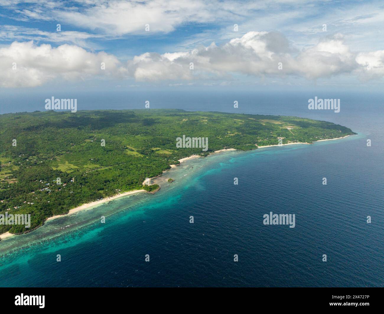 Tropical landscape of Island with beach surrounded by corals and blue ...