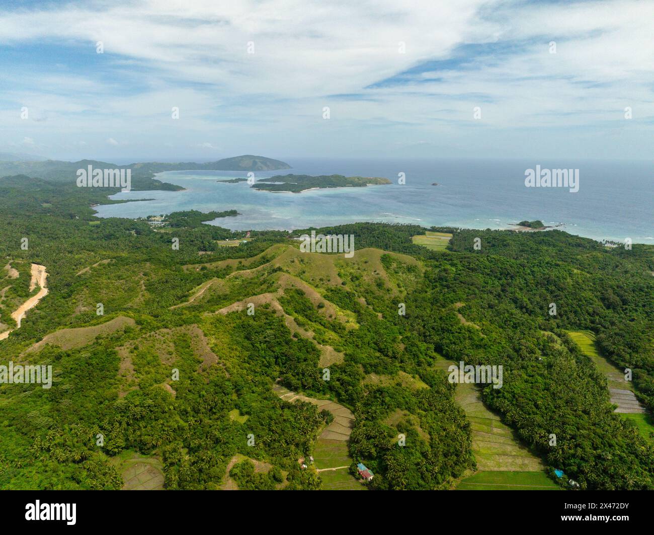 Island with green trees and turquoise water and coastal area. Santa Fe ...