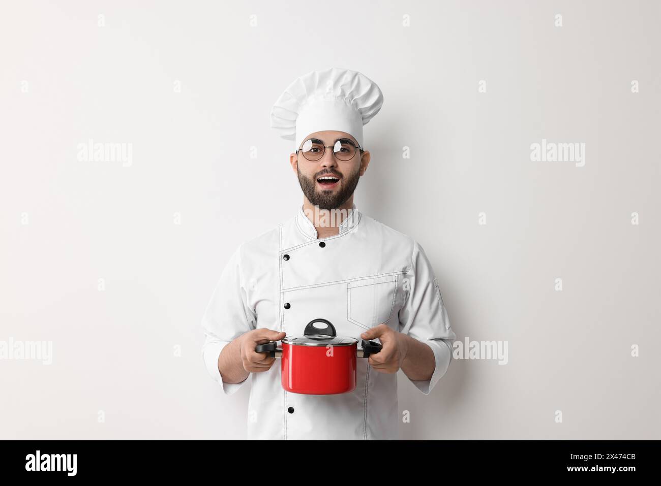Professional chef with cooking pot on white background Stock Photo - Alamy