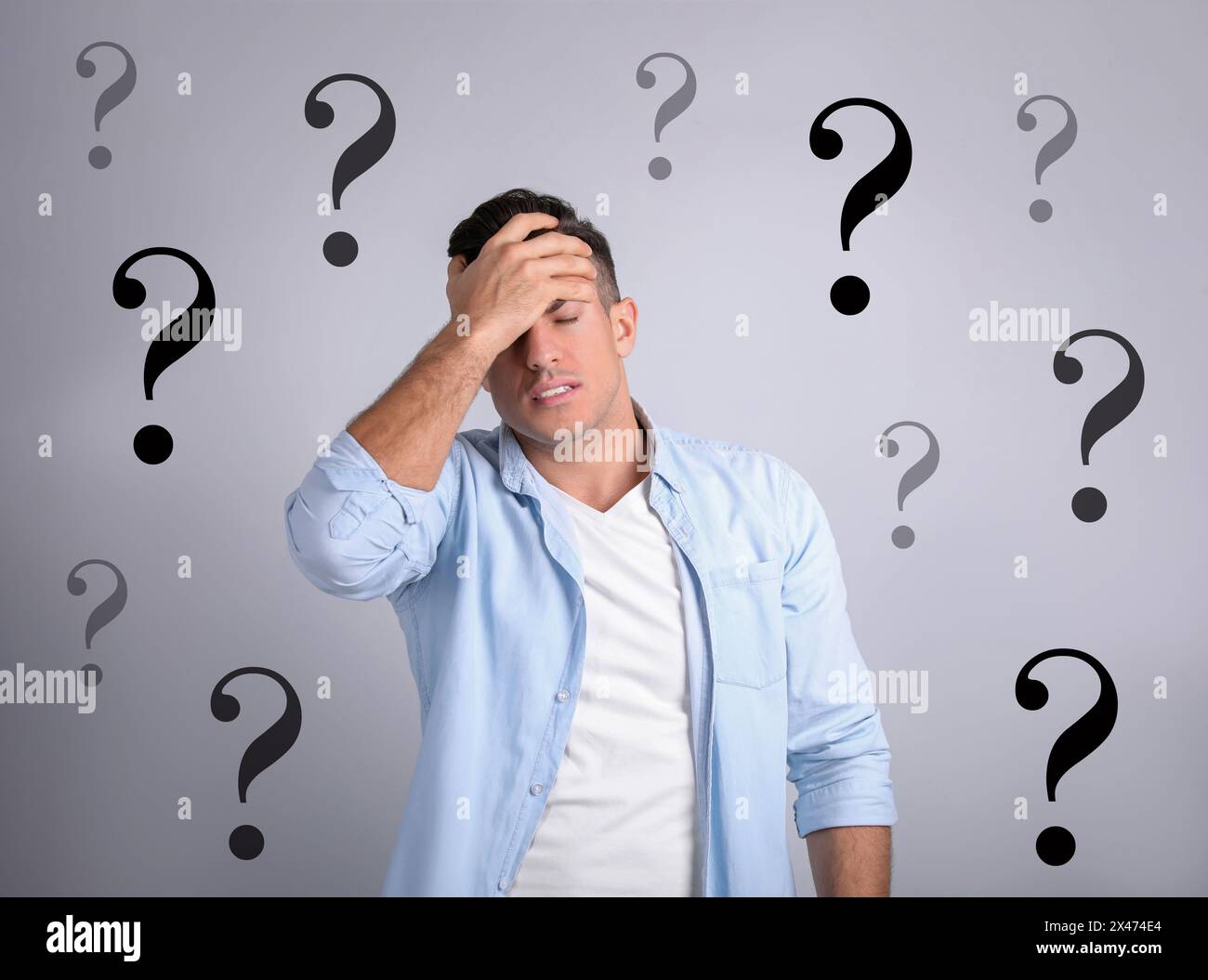 Amnesia. Confused man and question marks on light background Stock ...