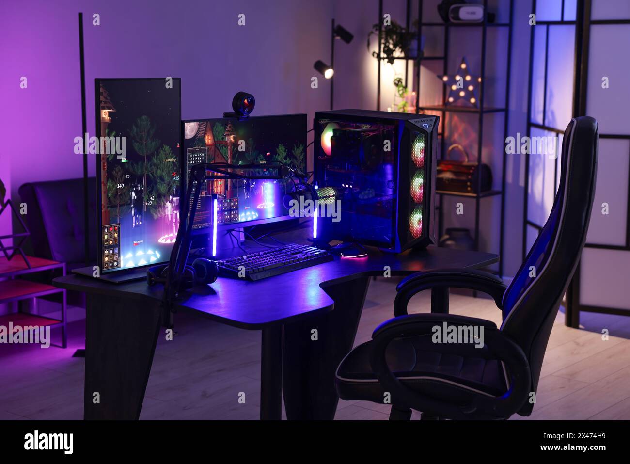 Playing video games. Stylish room interior with modern computer and ...