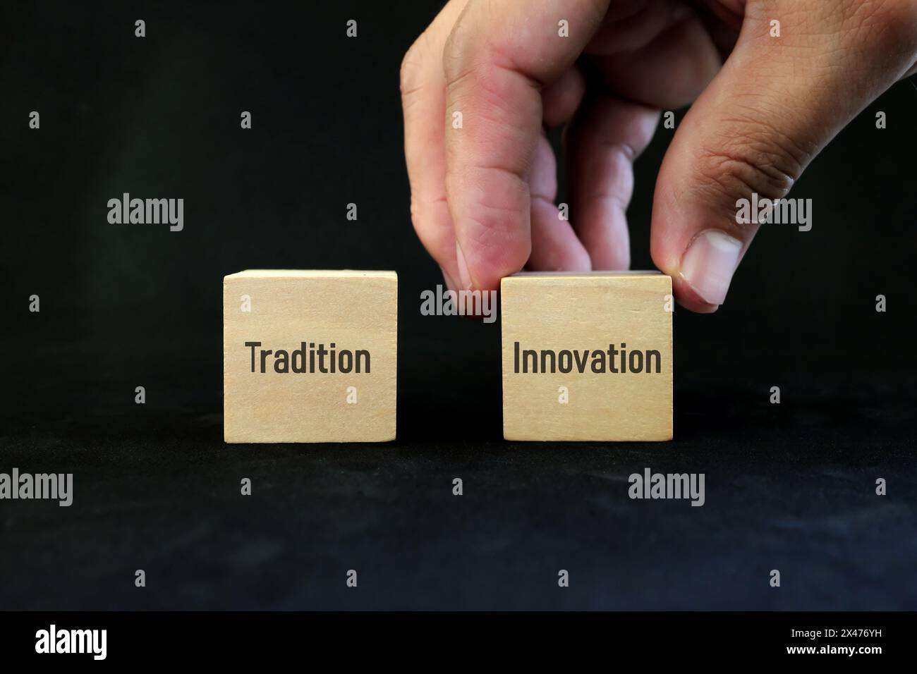 Hand choosing innovation over tradition concept. Wooden blocks on black ...