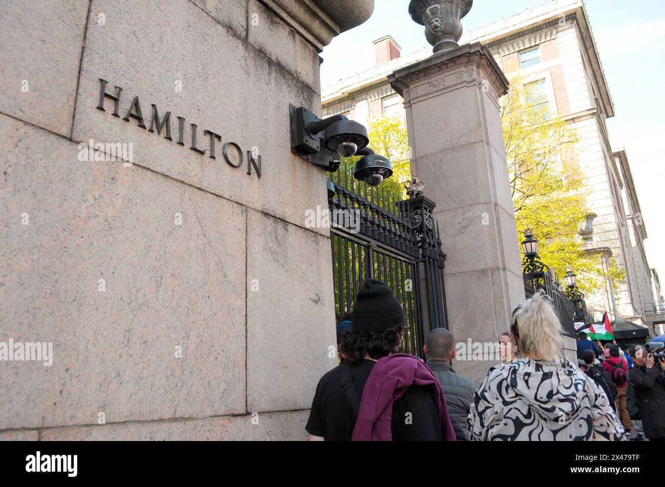 People stand next to Hamilton Hall in Columbia University near a pro ...