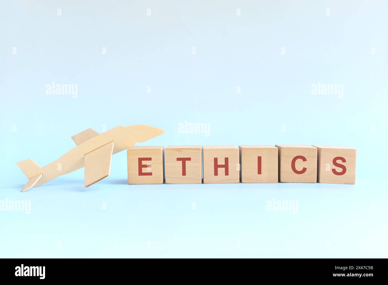 Air travel ethics concept. Wooden blocks typography with airplane model ...