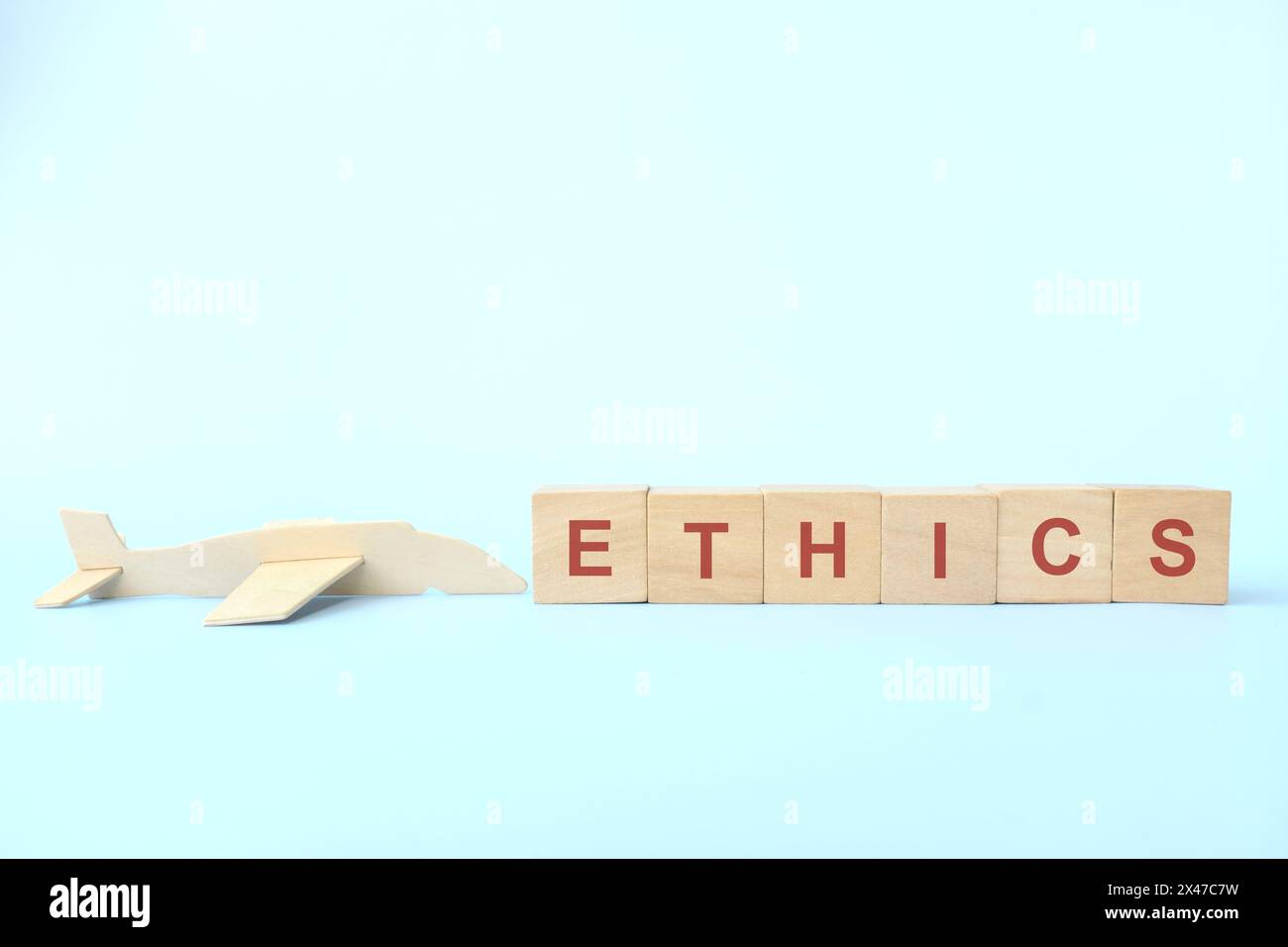 Air travel ethics concept. Wooden blocks typography with airplane model ...