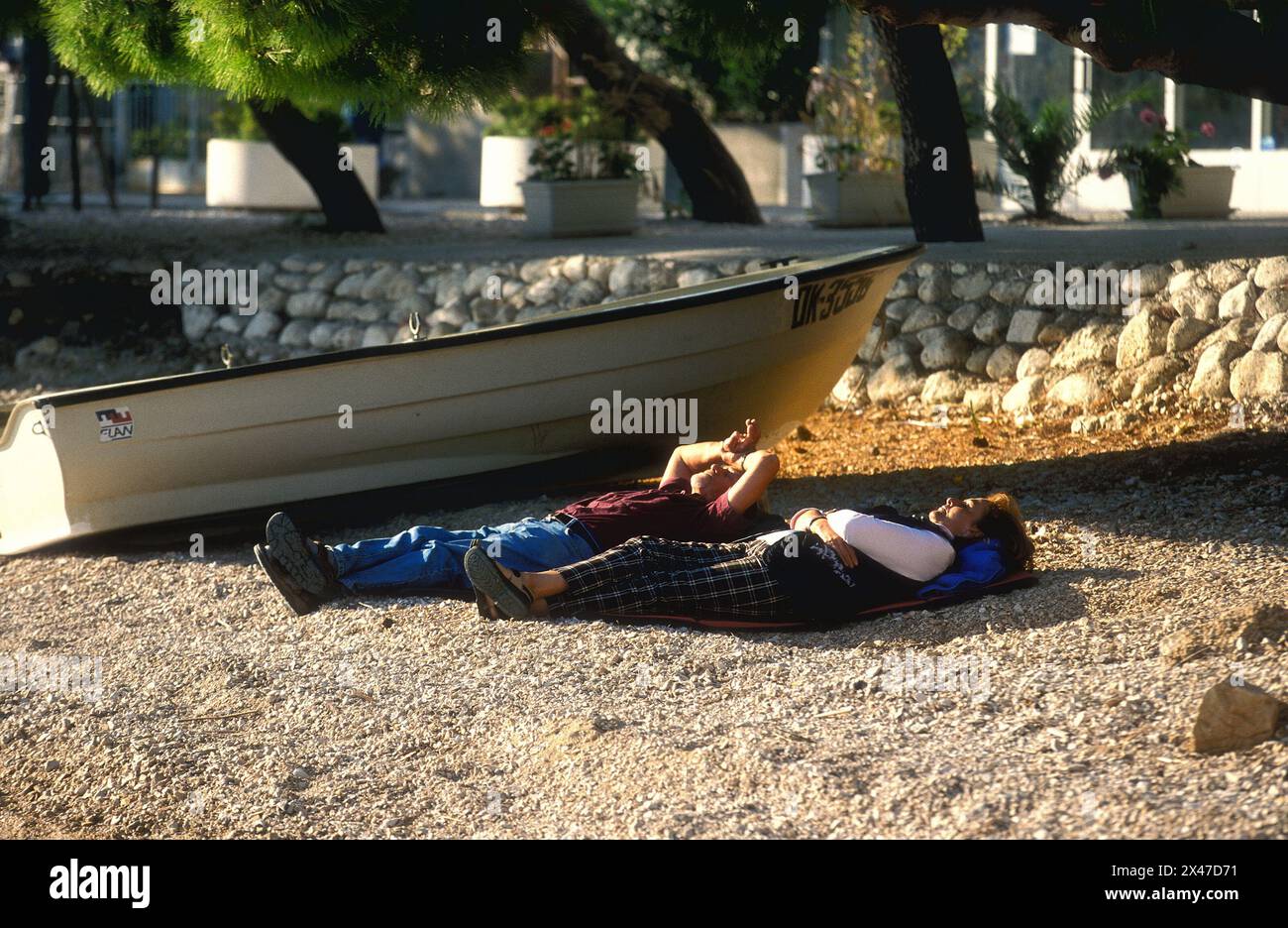 Man and Woman laying on a beach, Split, Croatia Stock Photo - Alamy