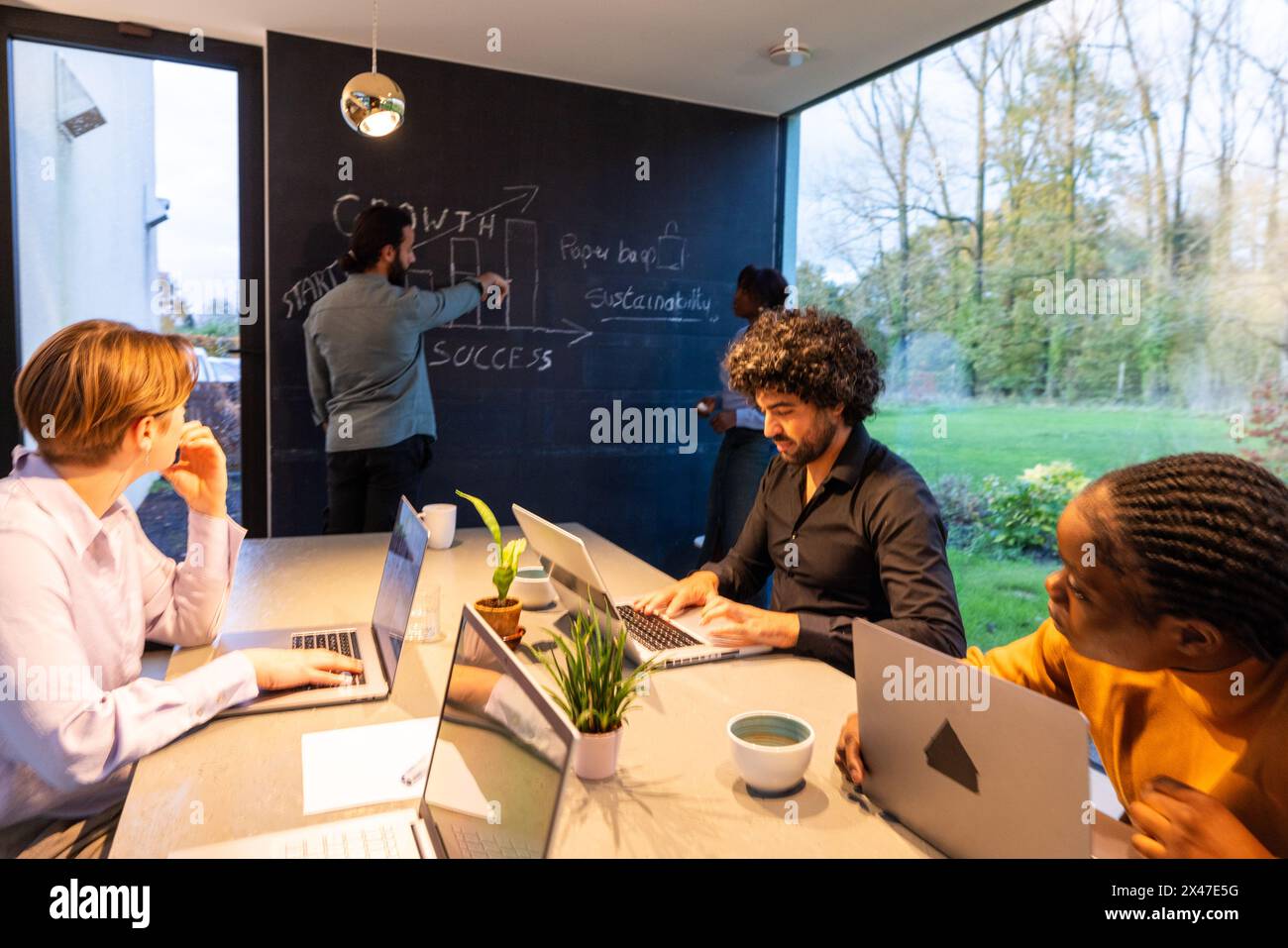 An animated business meeting unfolds with a diverse group of ...