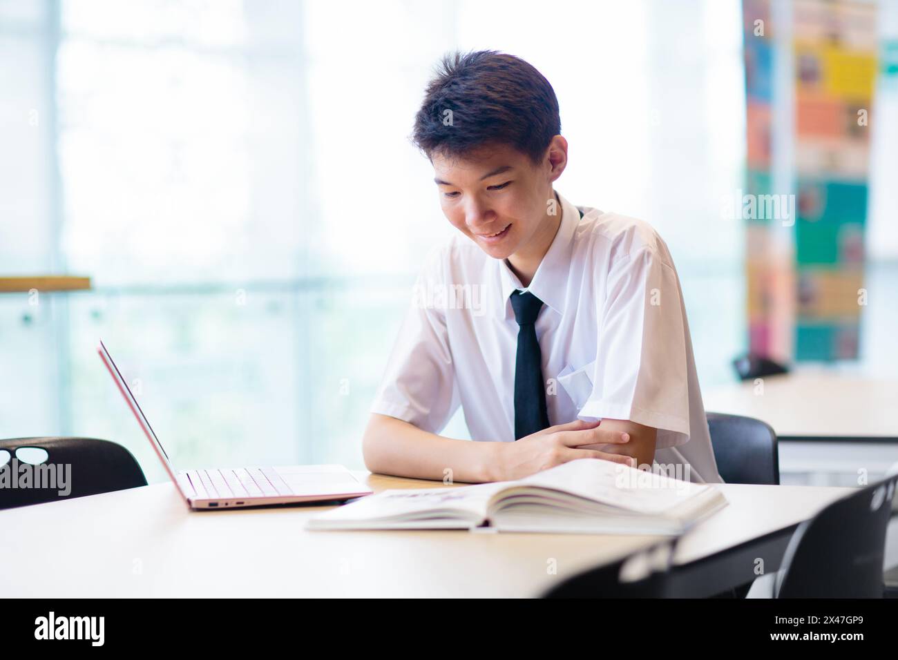 Asian boy with laptop in school. Student in classroom. Teenager in ...