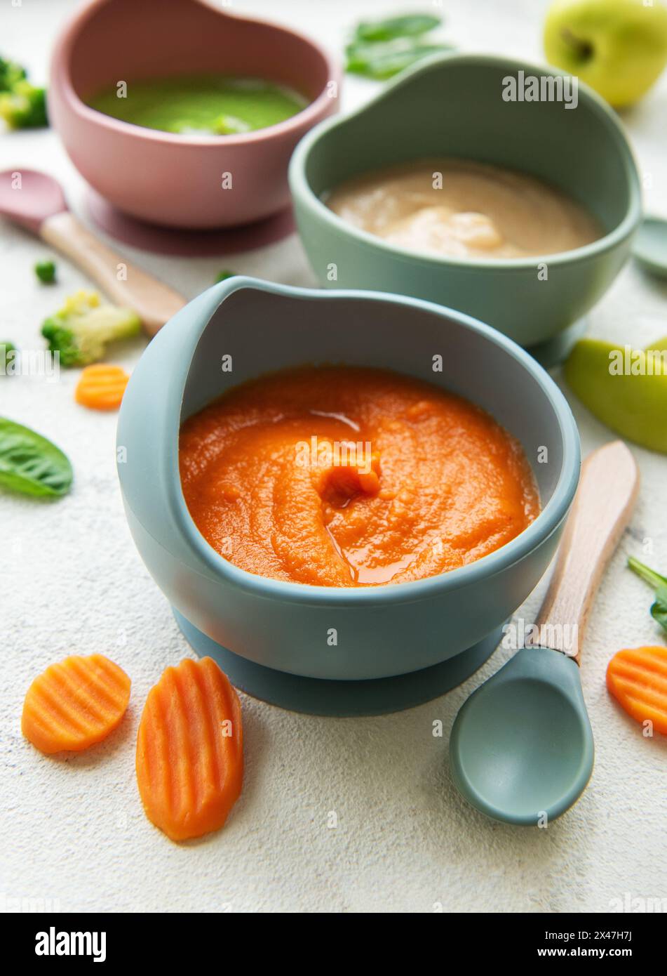Healthy baby food in bowls. Various bowls of fruit and vegetable puree ...