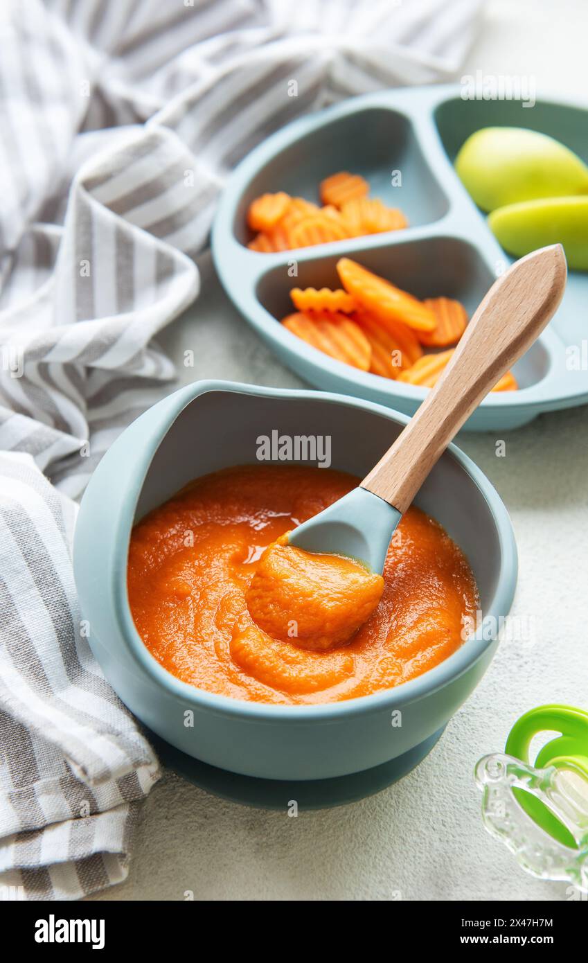 Healthy baby food in bowl. Baby food puree with carrot on white ...