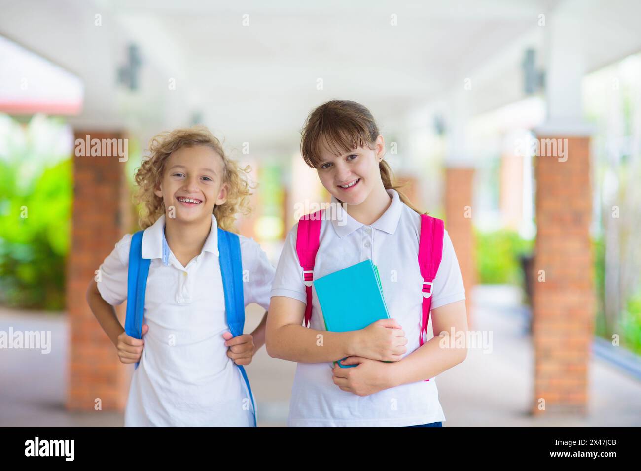 Kids go back to school. Happy little student with backpack and books on ...