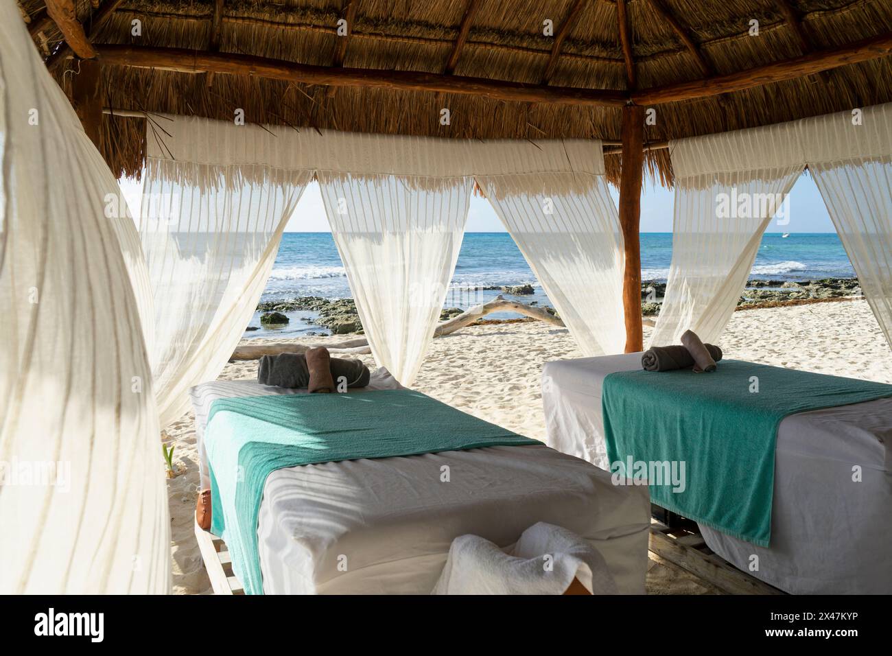 Caribbean beachfront and ocean view hut spa with empty massage table ...