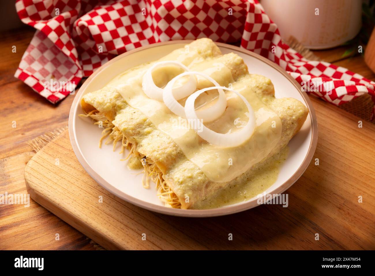 Mexican food. Enchiladas with creamy green sauce filled with shredded ...
