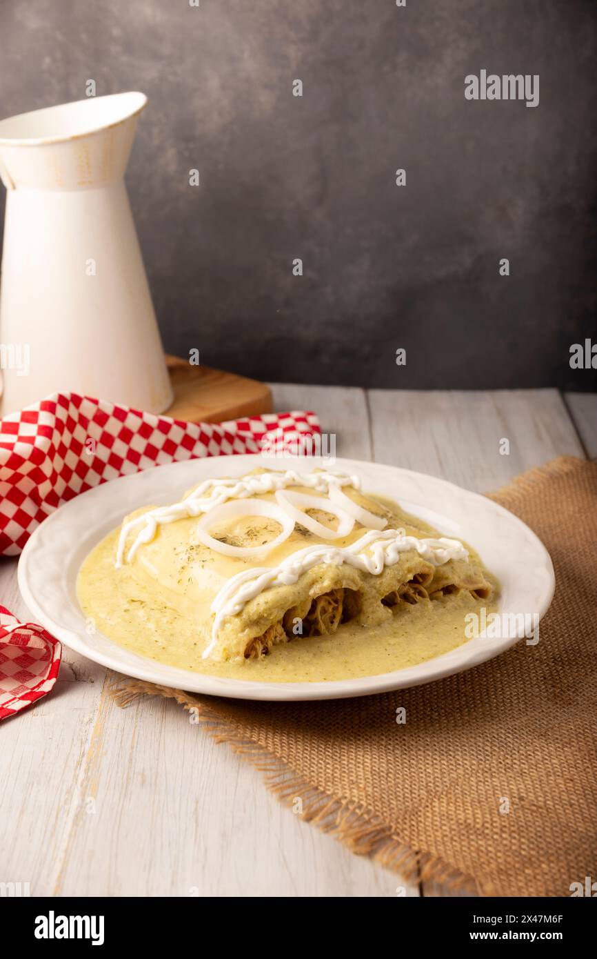 Mexican food. Enchiladas with creamy green sauce filled with shredded ...