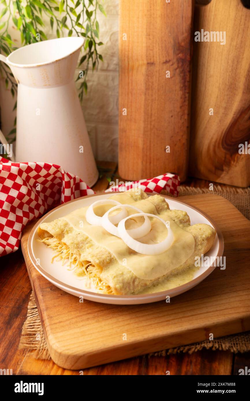 Mexican food. Enchiladas with creamy green sauce filled with shredded ...