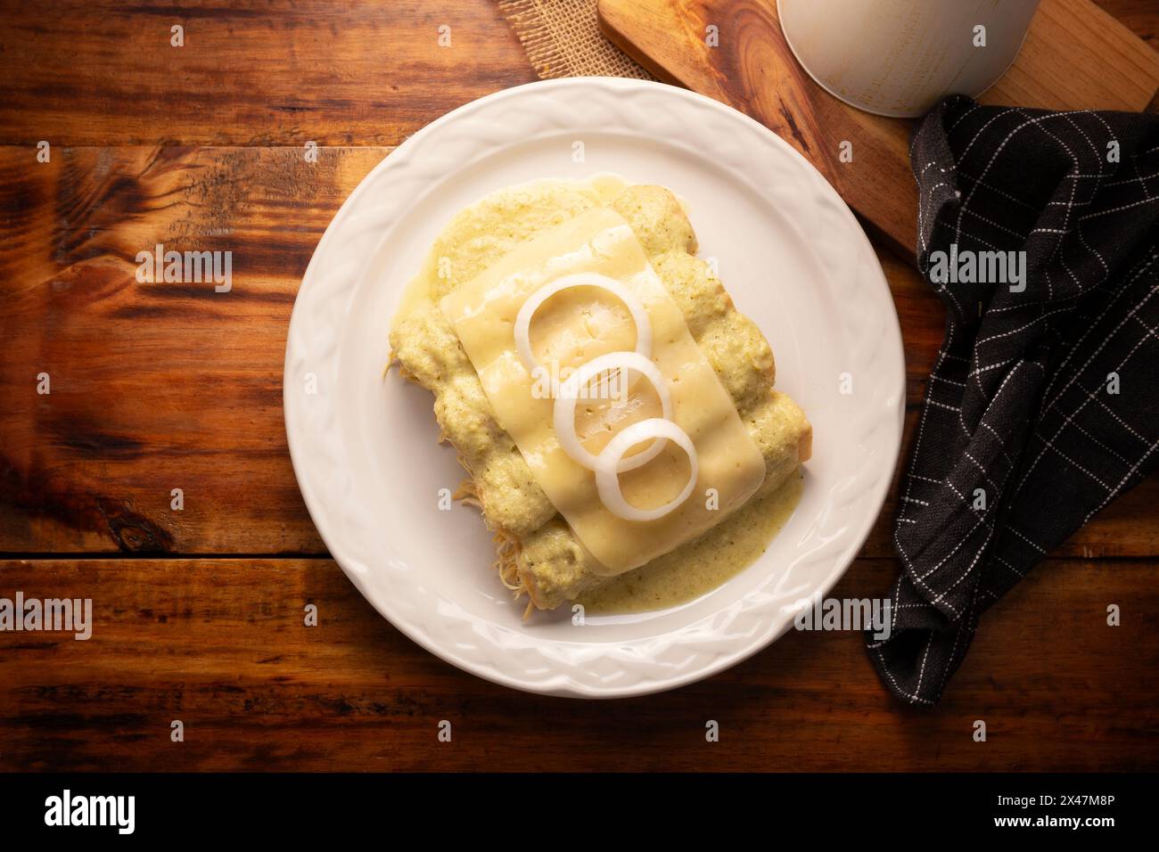 Mexican food. Enchiladas with creamy green sauce filled with shredded ...