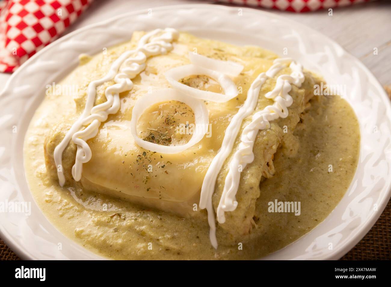 Mexican food. Enchiladas with creamy green sauce filled with shredded ...