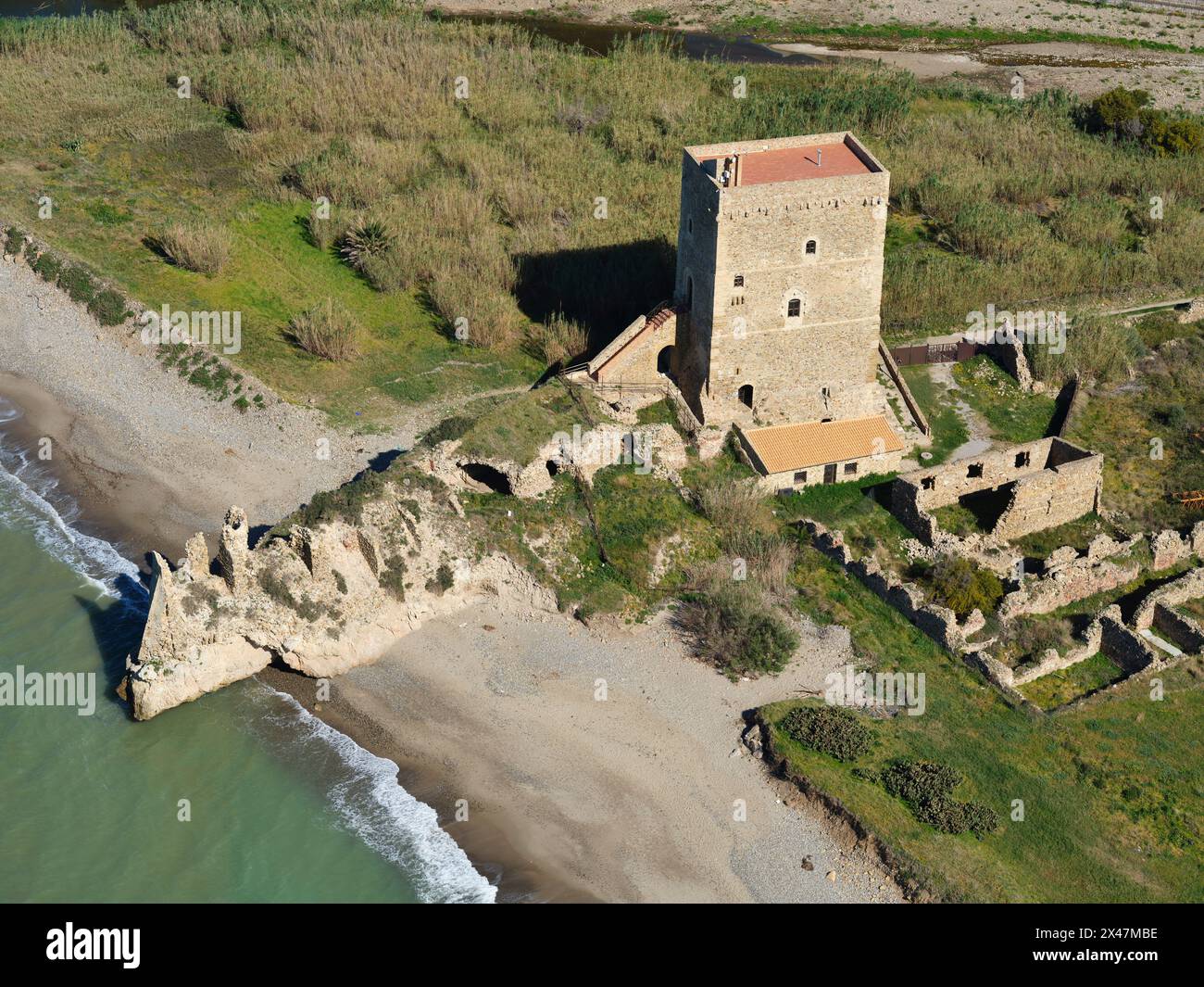 AERIAL VIEW. Ruins of Roccella Castle extending into the Tyrrhenian Sea ...