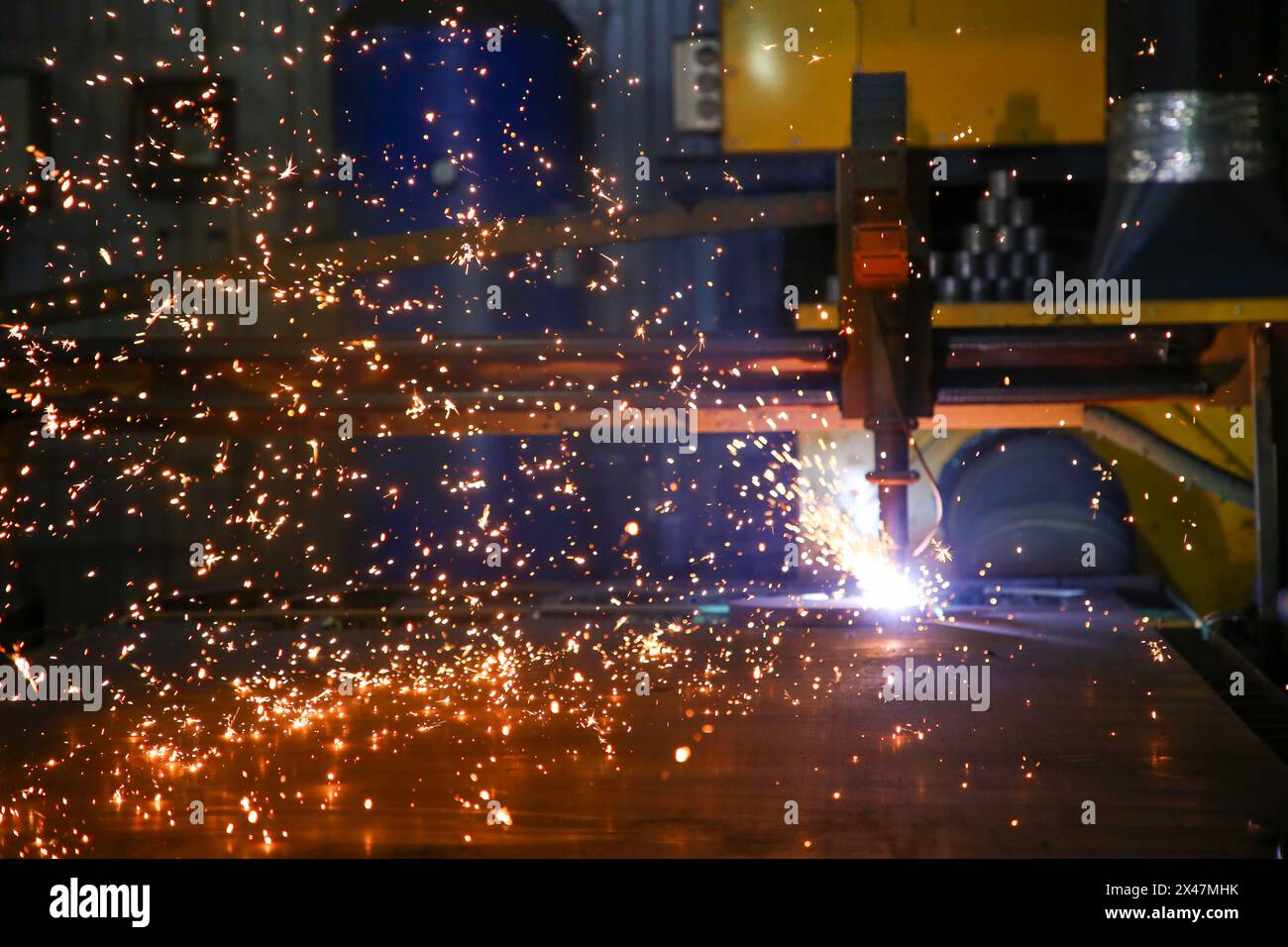 sparks flying while machine griding and finishing metal plasma cutting ...