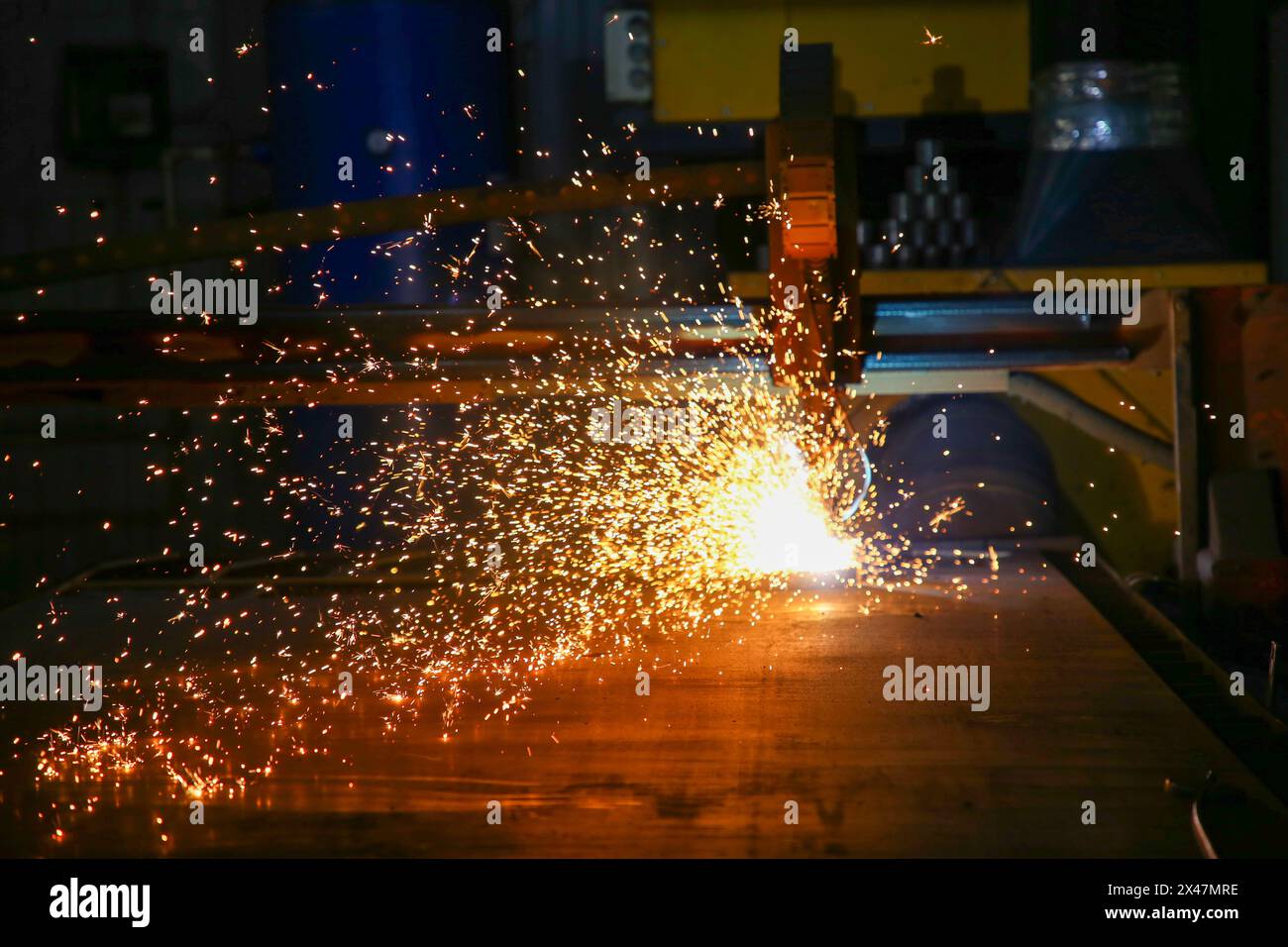 sparks flying while machine griding and finishing metal plasma cutting ...