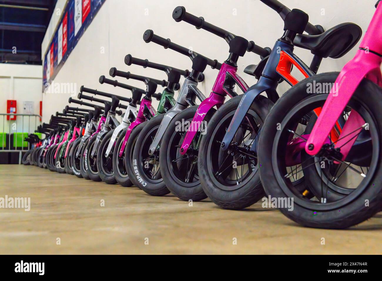 Children push along bikes lined up against a wall during the Le ...