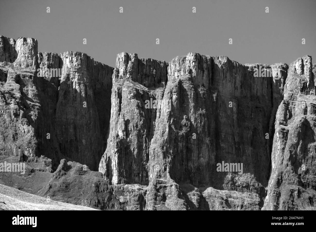 The impassable basalt cliffs of the Drakensberg Mountains in black and ...