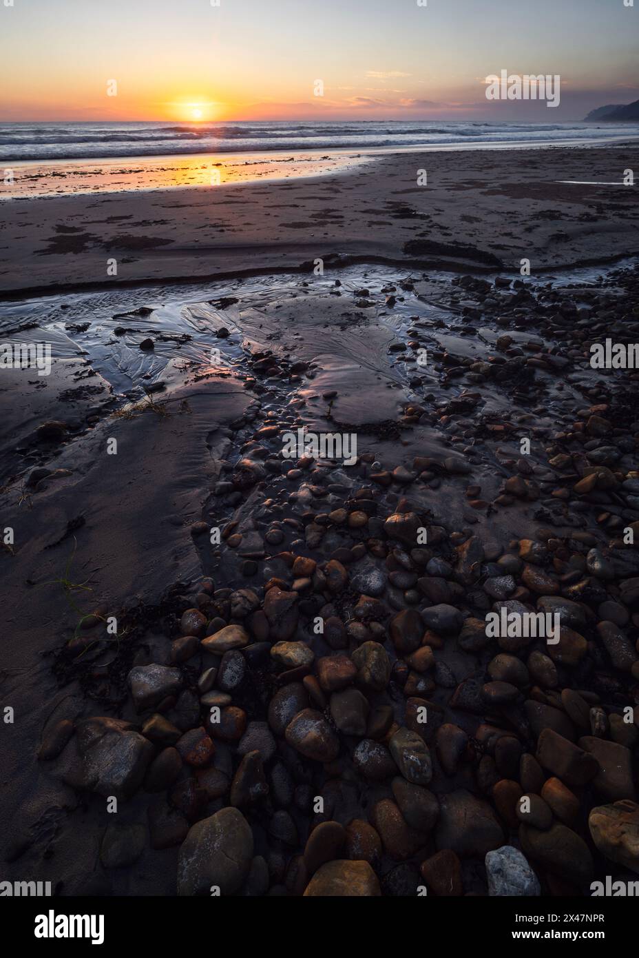 Pebbles in creek on beach at sunrise Minnie Water NSW coast of ...