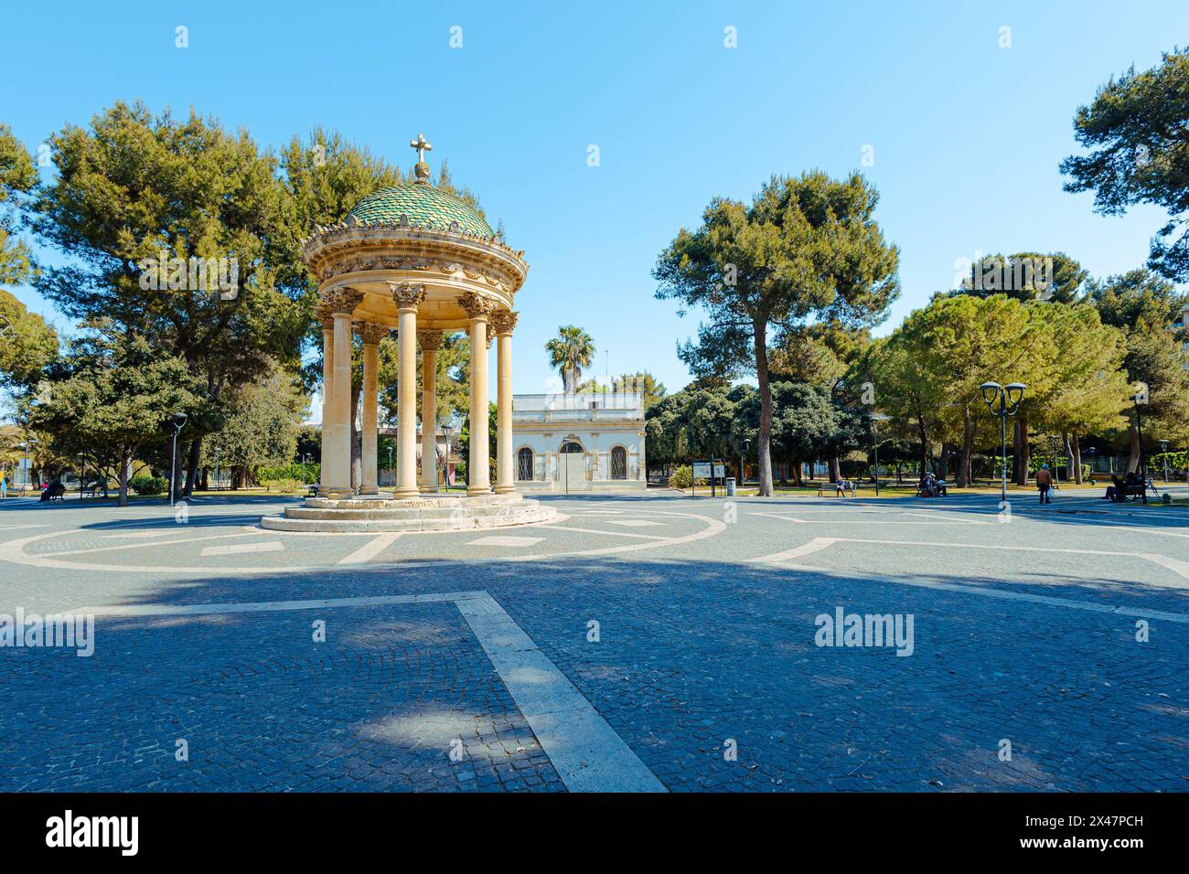 Central part of a big park in lecce, with round monument with pillars ...