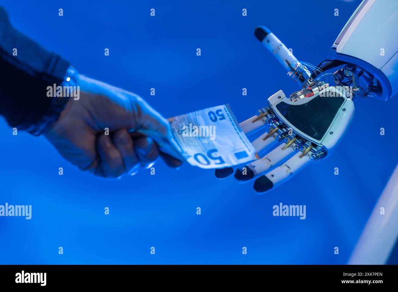 Hand of a person giving money 50eur to a robotic arm. Robot receiving ...