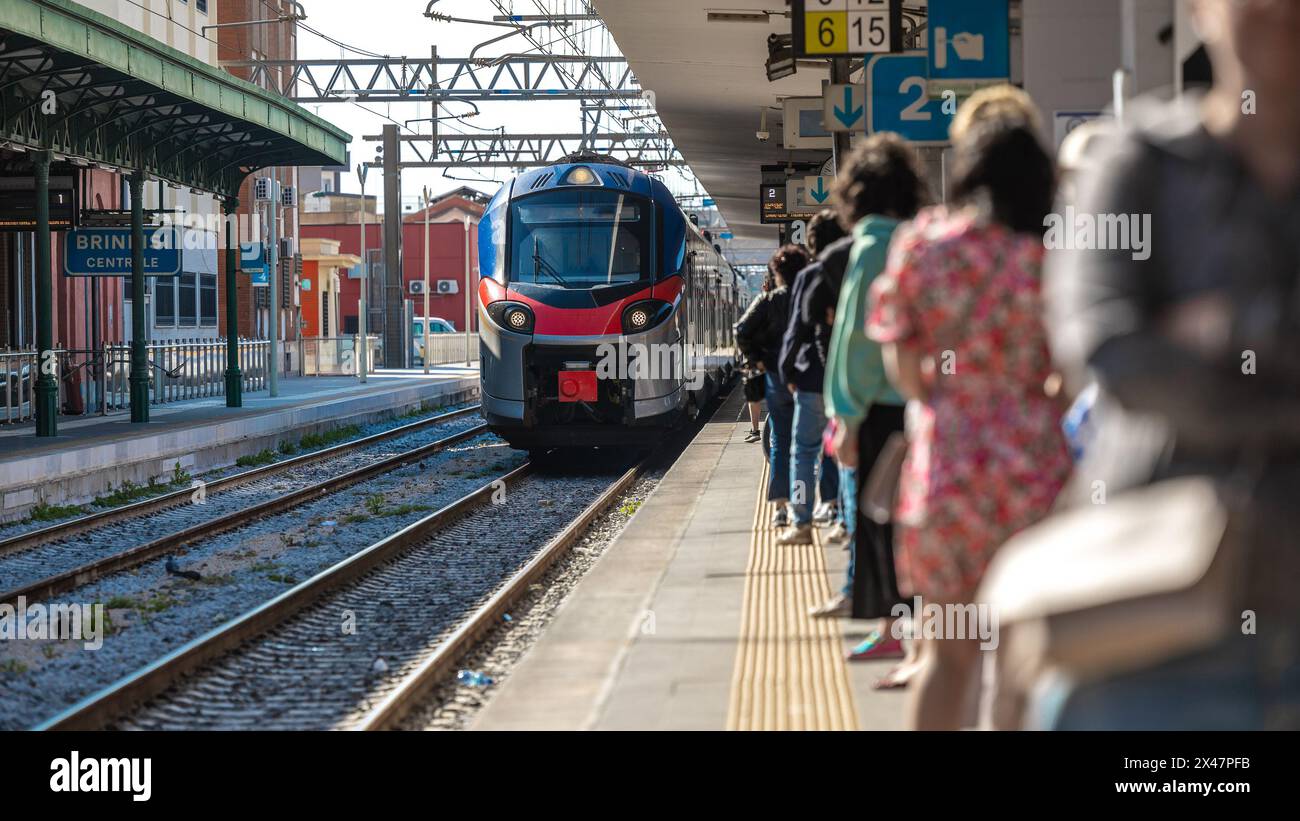People waiting on a commuter train, modern passenger train, on a ...