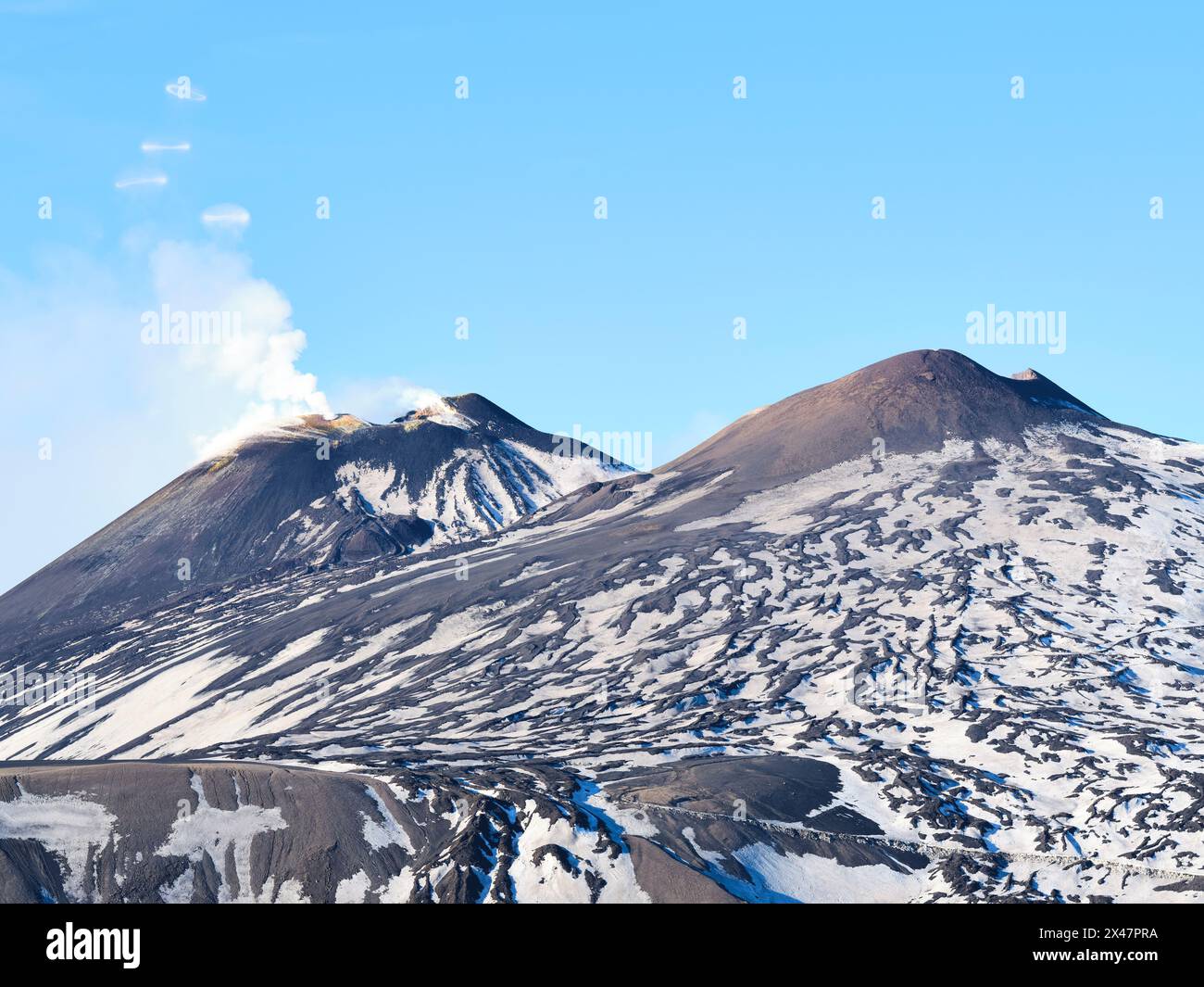 AERIAL VIEW. Summit of Mount Etna blowing volcanic smoke rings (vortex ...