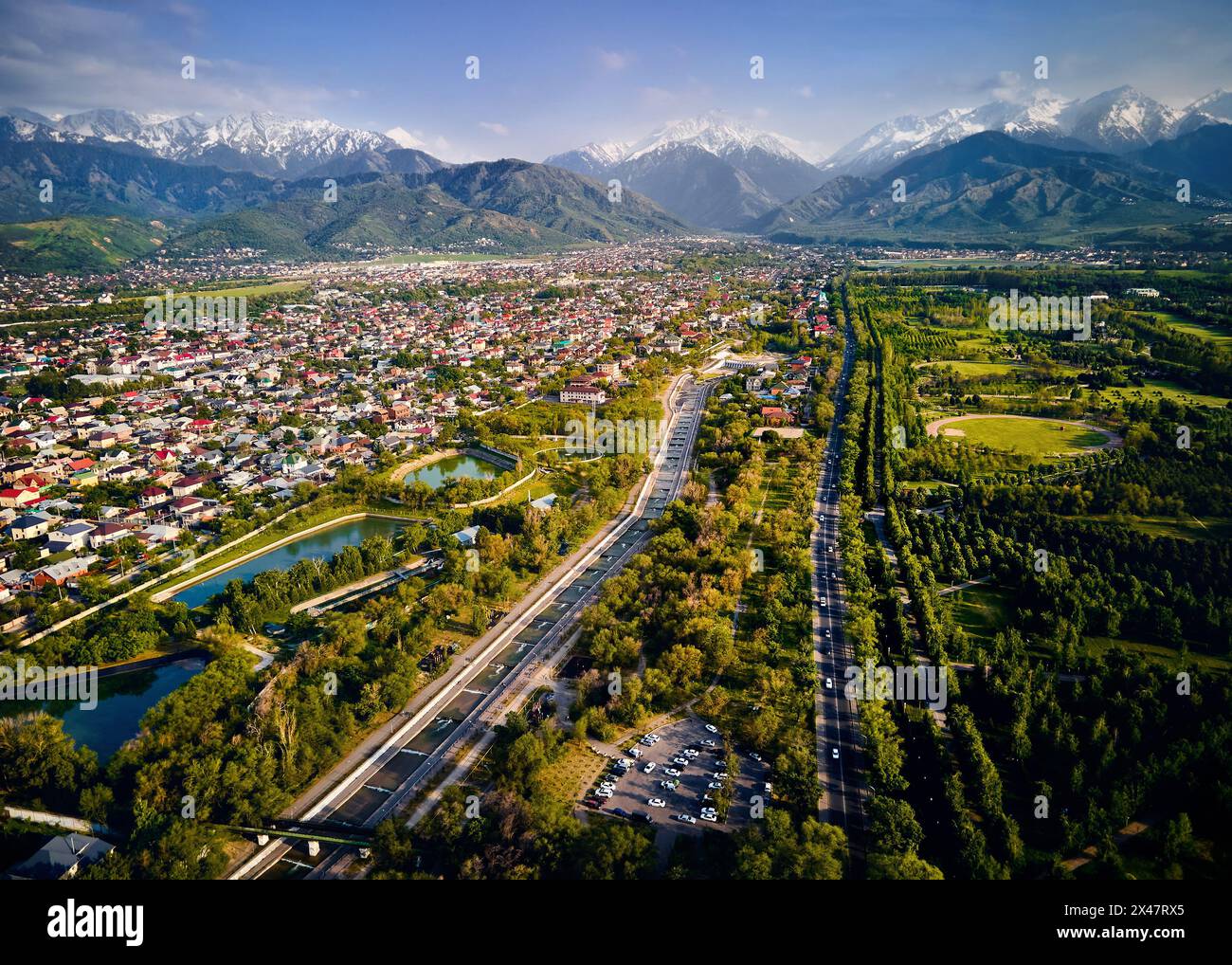 Aerial drone view panorama of big Almaty river and houses with scenery ...
